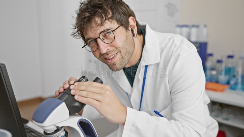 Man in a Lab Coat Using a Microscope To Examine a Sample, Suitable for ...