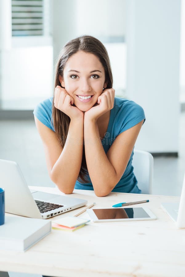 Smiling Beautiful Girl Posing at Desk Stock Image - Image of connecting ...