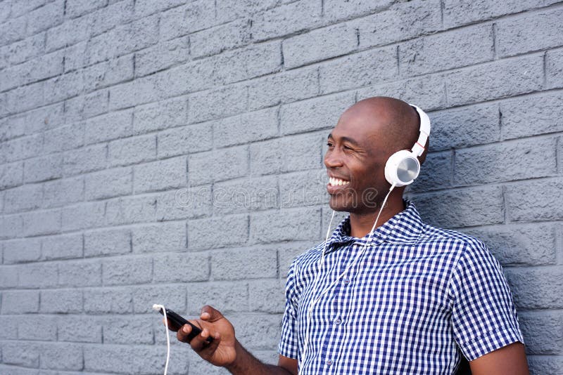 Smiling Black Guy with Headphones and Mobile Phone Stock Image - Image ...