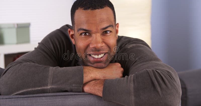 Smiling Black Man Resting on Couch Stock Photo - Image of good ...