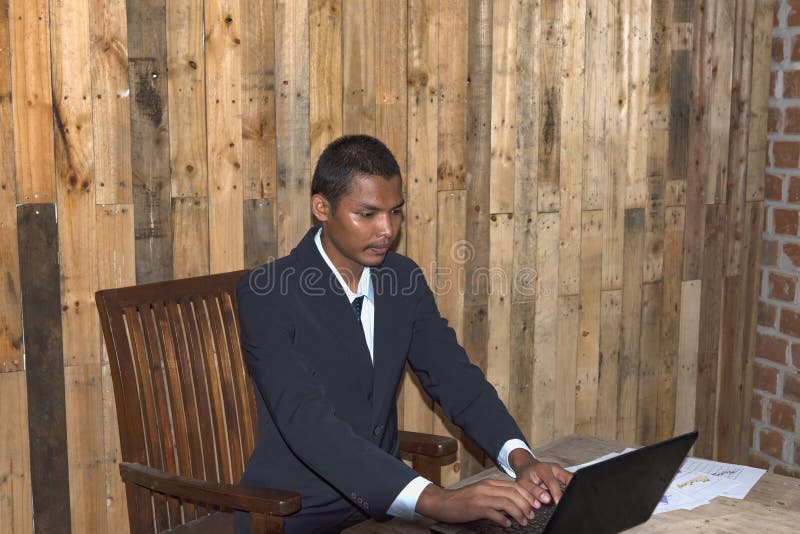 A Smiling Black Manager Uses a Laptop. Stock Photo - Image of ...
