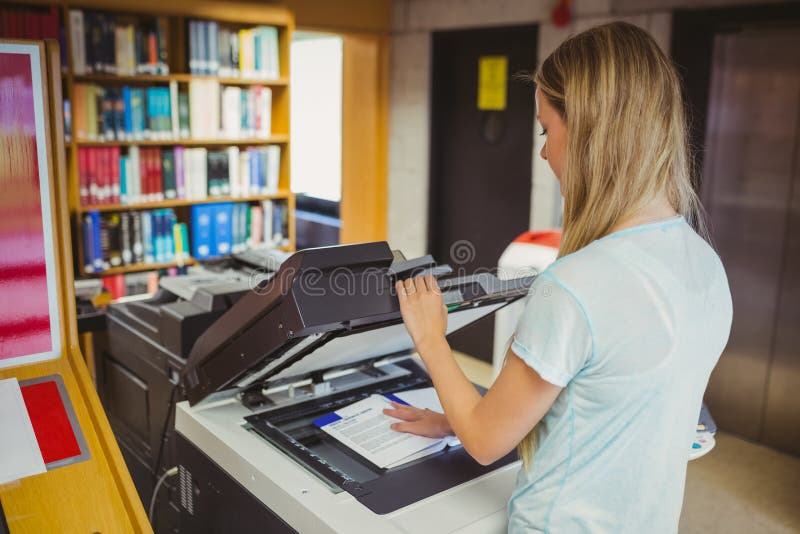 Smiling Blonde Student Making a Copy Stock Image - Image of bookshelves ...
