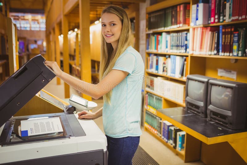 Smiling Blonde Student Making a Copy Stock Image - Image of library ...
