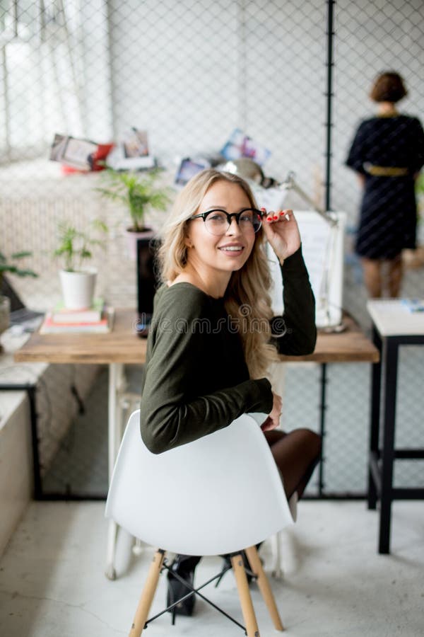 Smiling Blonde Woman Sitting On Office Chair Young Assistant At The