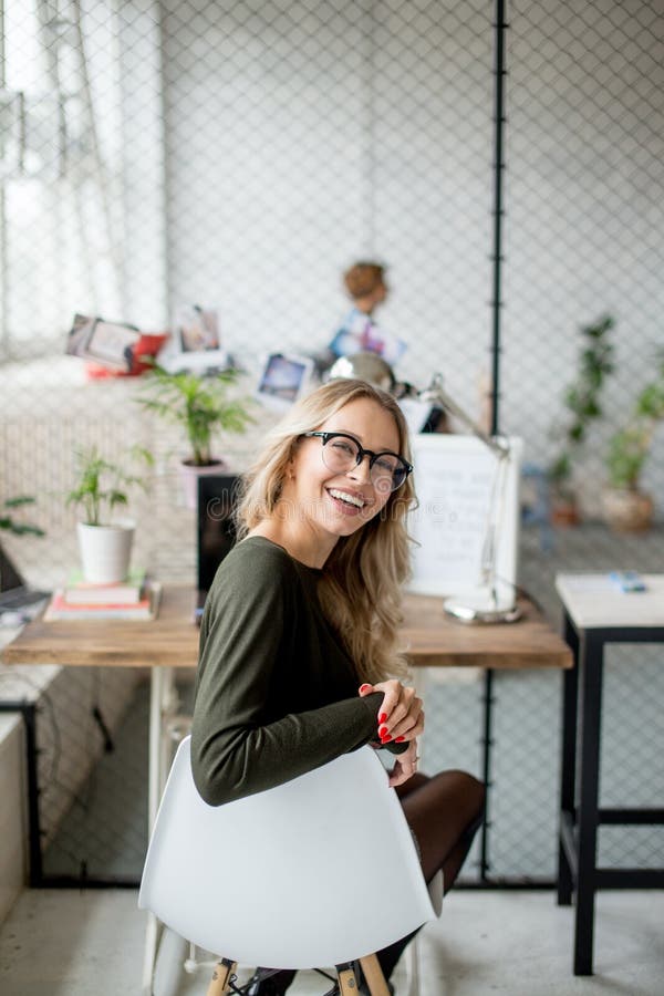 Smiling Blonde Woman Sitting On Office Chair Young Assistant At The