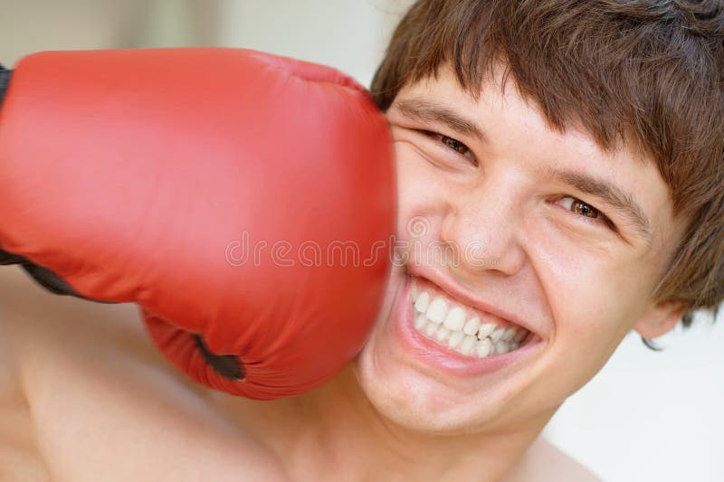 Smiling boxer gets a punch stock photo. Image of attack - 20538756