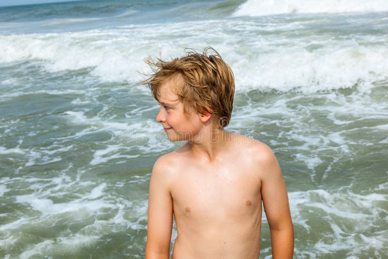 Smiling boy at the beach stock photo. Image of ocean - 34444142
