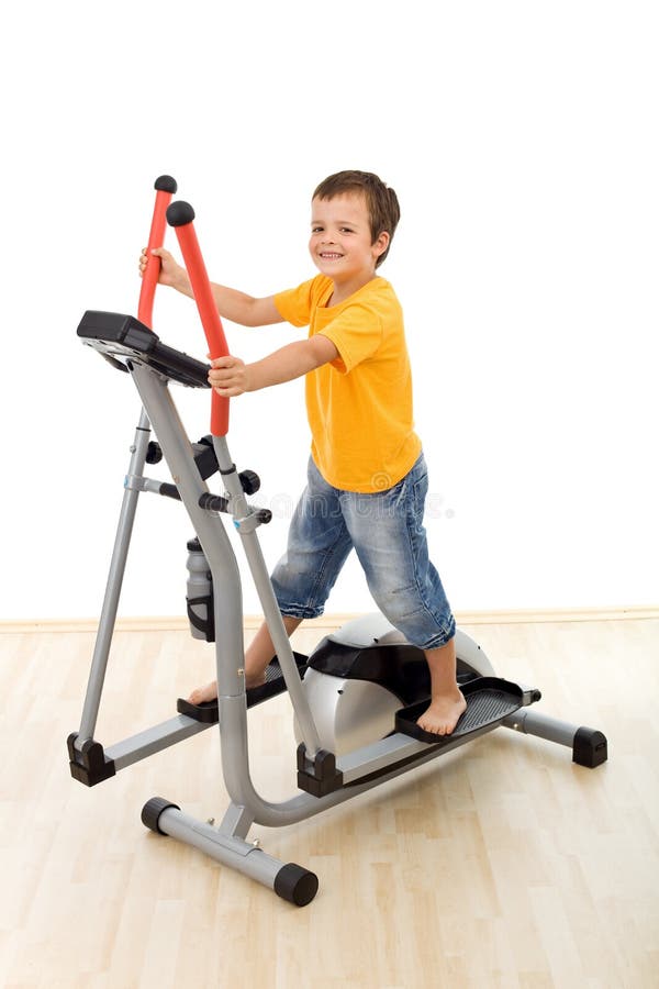 Smiling Boy on Elliptical Trainer in the Gym Stock Photo - Image of ...