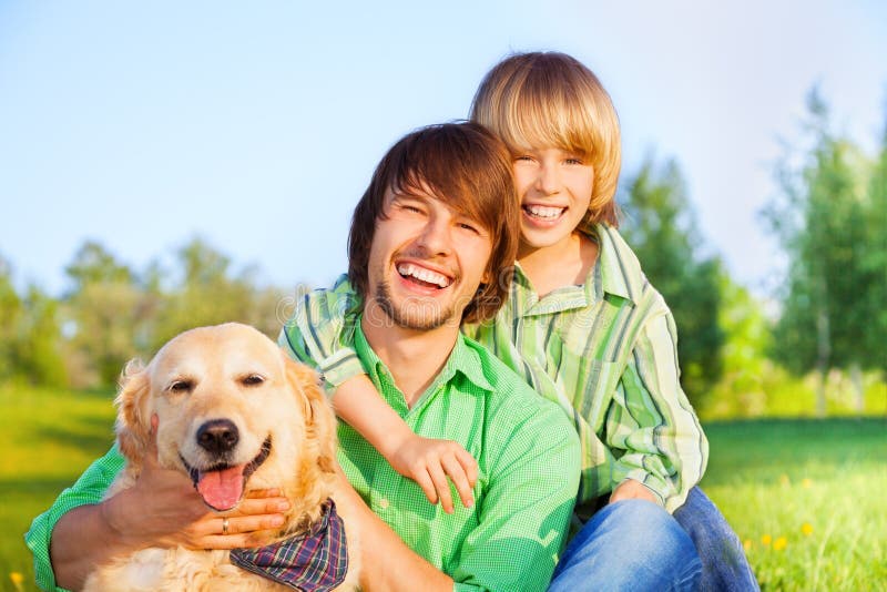 Smiling Boy, Father and Dog Sit in Park on Grass Stock Image - Image of ...