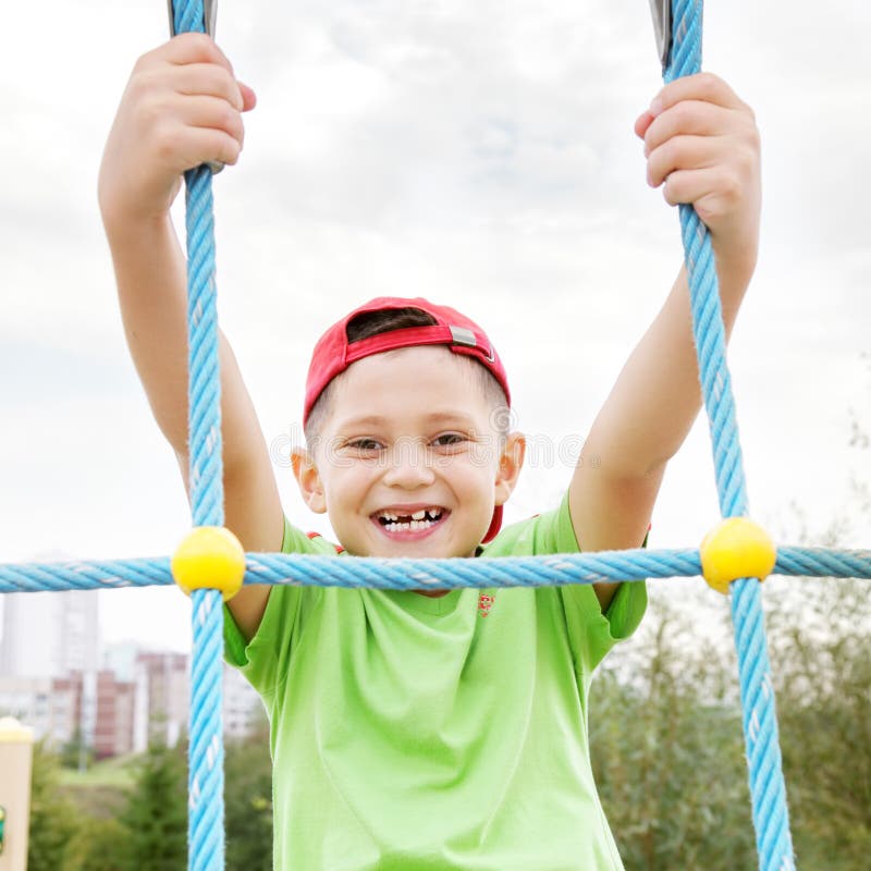 Smiling Boy Hanging on Ropes Stock Photo - Image of hanging, ropes ...