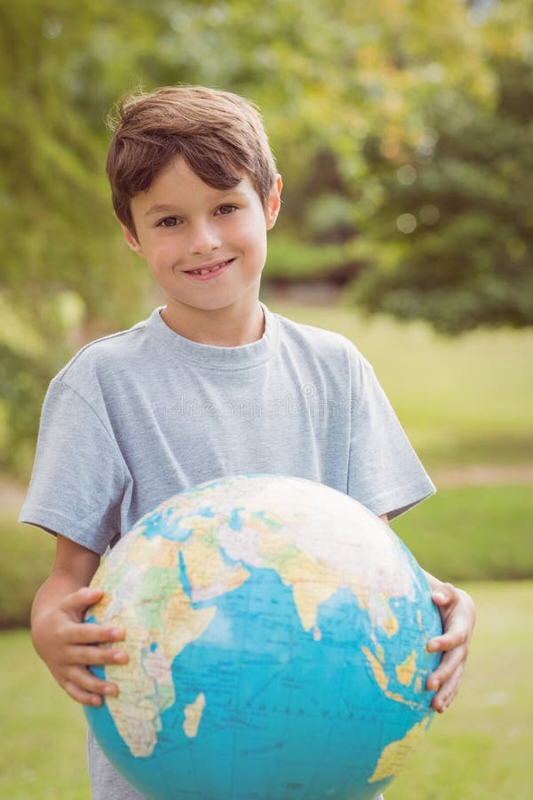 Smiling Boy Holding an Earth Globe in the Park Stock Image - Image of ...