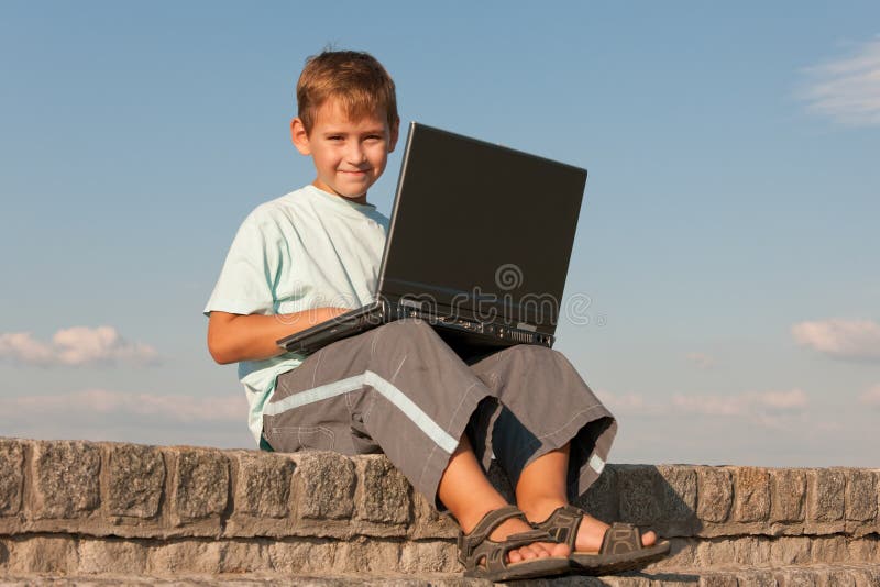 Smiling Boy Holding a Laptop Stock Photo - Image of connection, emotion ...