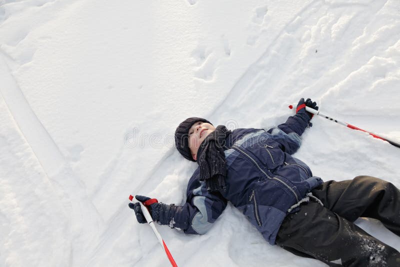 Smiling Boy Laying Down on Snow Stock Photo - Image of healthy, laying ...