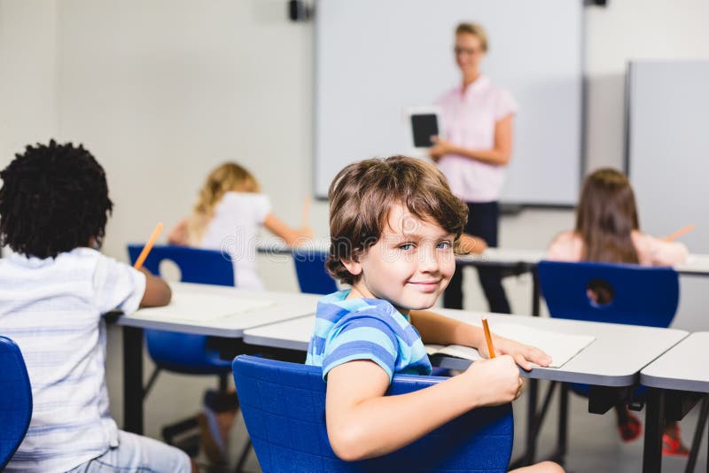 Smiling Boy Looking at Camera during Lesson Stock Image - Image of ...