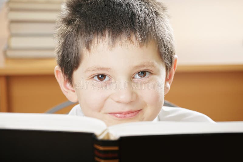 Smiling Boy Looking Over Book Stock Photo - Image of clever, horizontal ...