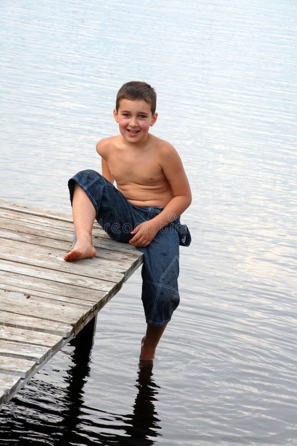 Smiling boy on the pier stock image. Image of sitting - 5048335