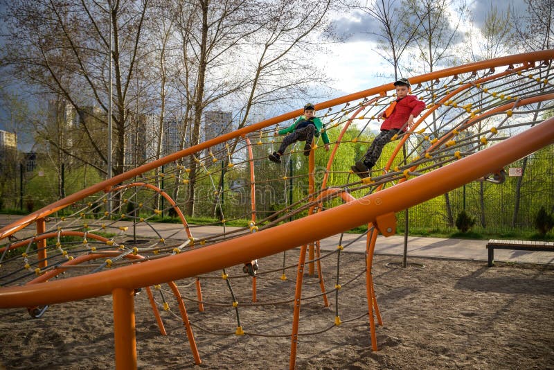 Smiling Boy Playing on Blue Rope Modern Playground Stock Photo - Image ...