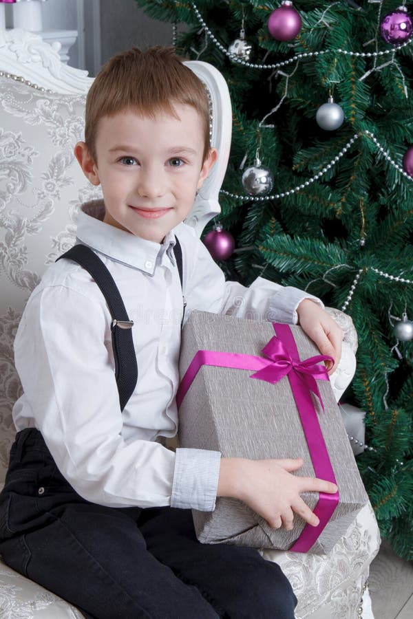 Smiling Boy with Present Under Christmas Tree Stock Photo - Image of ...