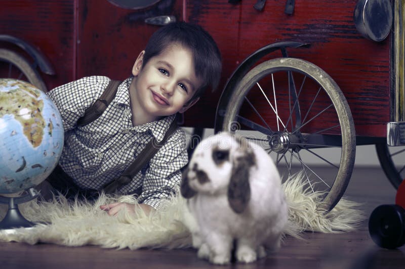 Smiling boy with rabbit stock image. Image of cheerful - 31682129