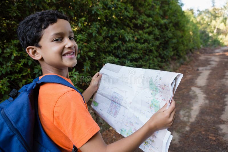 Smiling Boy Reading the Map while Walking on the Path Stock Image ...