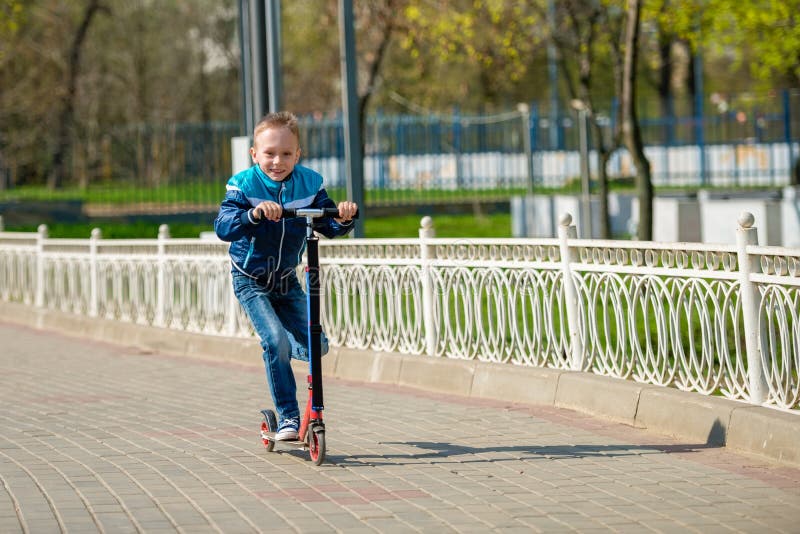 Smiling Boy Riding a Scooter Stock Image - Image of learn, leisure ...