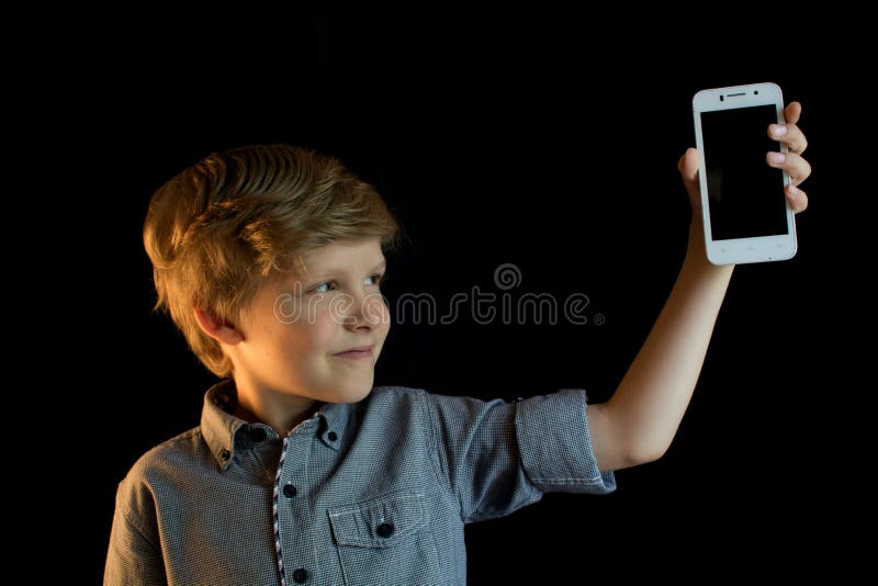 Smiling Boy Showing Mobile Phone. Isolated. Looking at Camera Stock ...