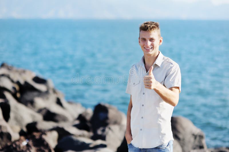 Smiling Boy Showing Thumb Up on Sea Background Stock Photo - Image of ...