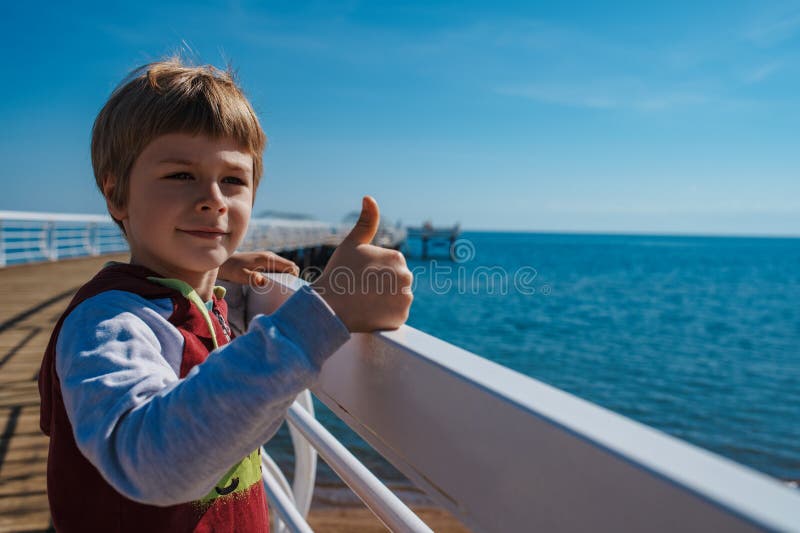 Smiling Boy Shows Thumbs Up Standing on the Pier Stock Photo - Image of ...