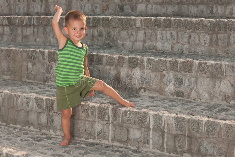 Smiling Boy on the Stone Steps Stock Photo - Image of striped, outdoors ...