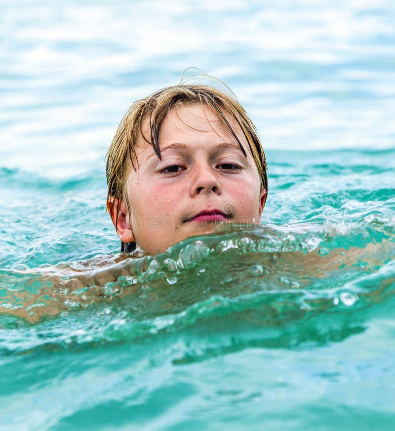 Smiling Boy Swimming in the Ocean Stock Photo - Image of positive ...