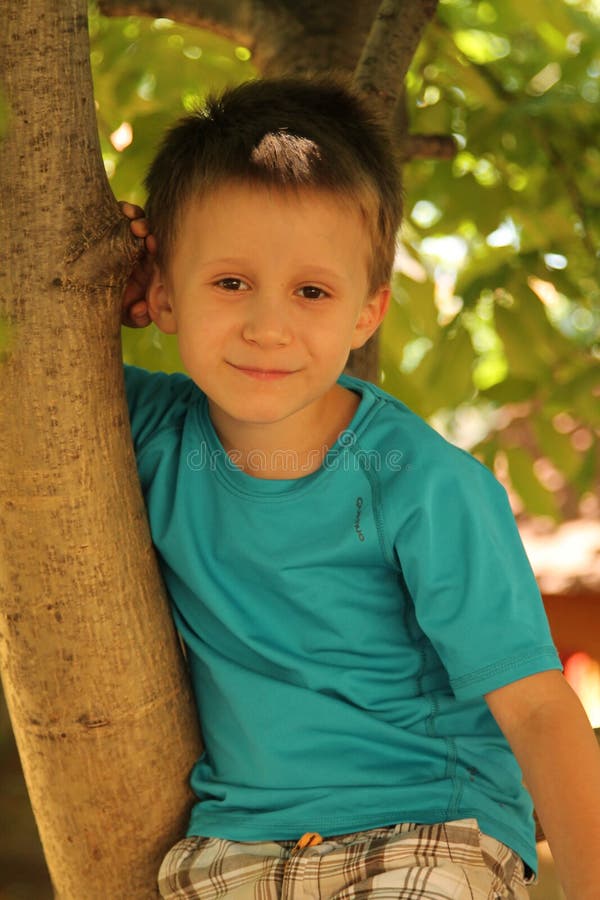 Smiling Boy on the Tree stock image. Image of human, pensive - 46606561