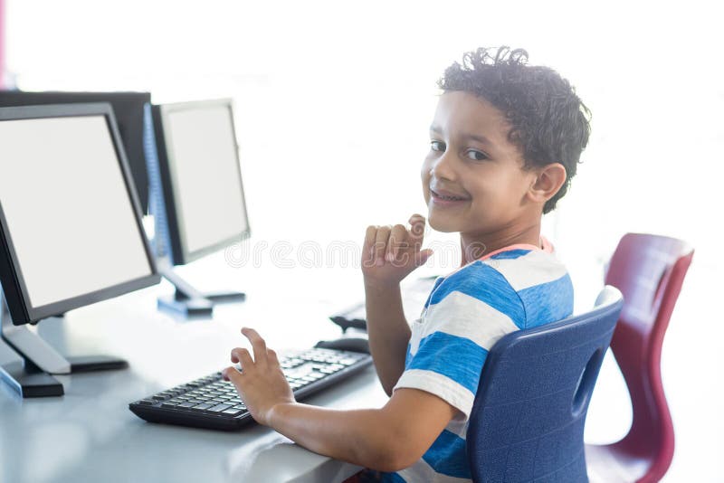 Smiling boy using computer stock photo. Image of casual - 77704012