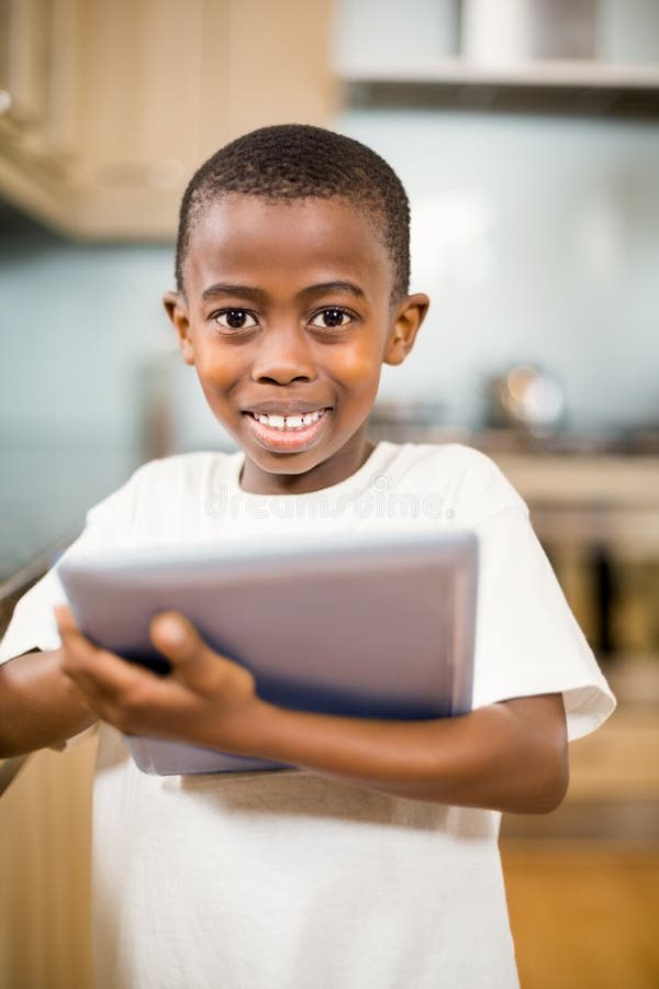 Smiling boy using tablet stock image. Image of cooker - 65328717
