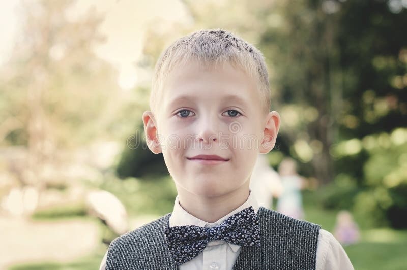 Smiling Boy in Vest and Bowtie Looking at Camera Stock Photo - Image of ...