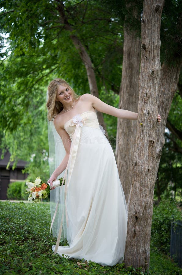 Smiling Bride Leaning Out from a Tree Stock Image - Image of beads ...