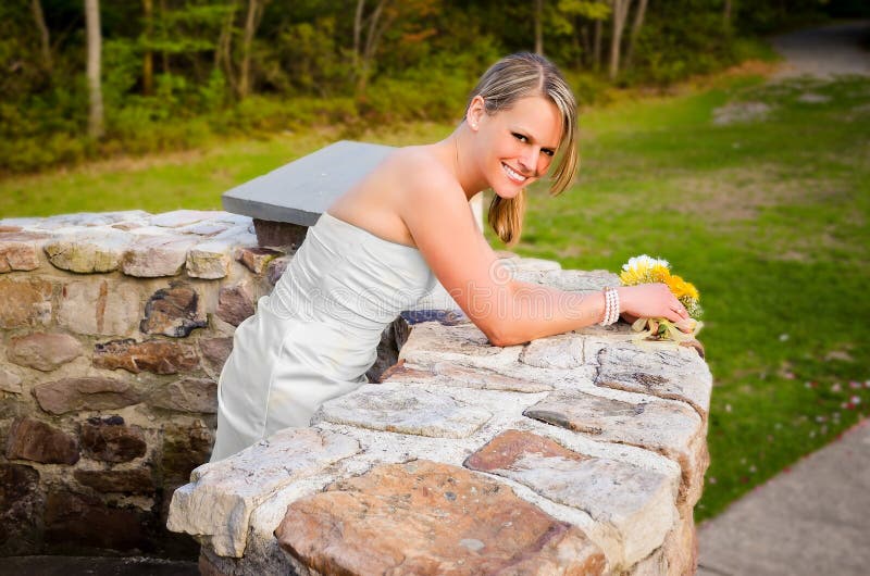 Smiling Bride Leaning on Stone Wall Stock Image - Image of bride, face ...