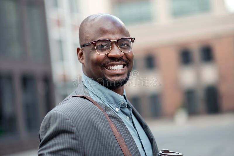 Young Businessman Smiling Broadly while Feeling Motivated Stock Image ...