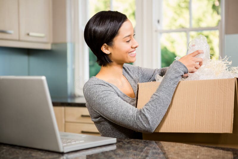 Smiling Brunette Opening Box Stock Photo - Image of cool, laptop: 65336916