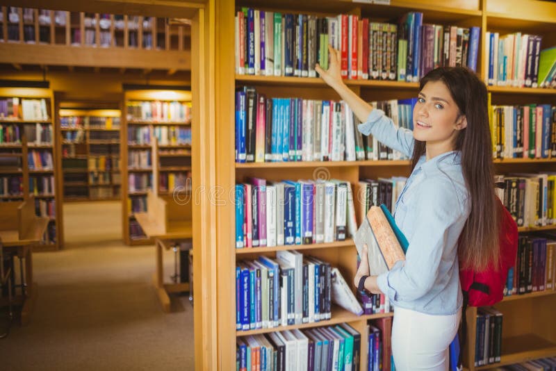 Student Picking a Book from Shelf in Library Stock Photo - Image of ...