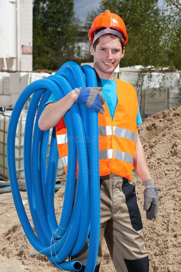 Smiling builder with pipes stock photo. Image of service - 42766708