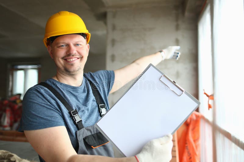 Smiling Builder Worker in Hard Hat Holding Blank Sheet of Paper on ...