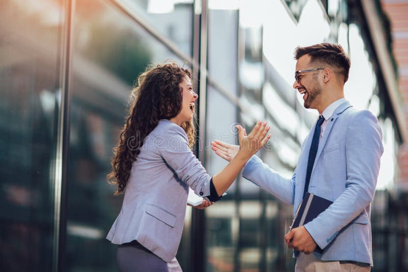 Two People Waving Hello