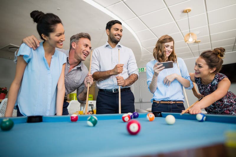 Smiling Business Colleagues Playing Pool Stock Image - Image of ...