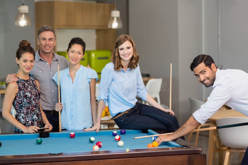 Smiling Business Colleagues Playing Pool in Office Space Stock Photo ...
