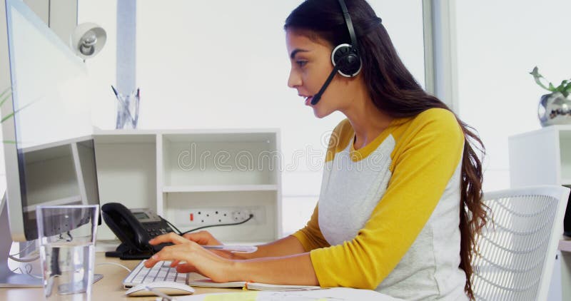 Executive with Headsets Using Computers at Desk in Office 4k Stock ...