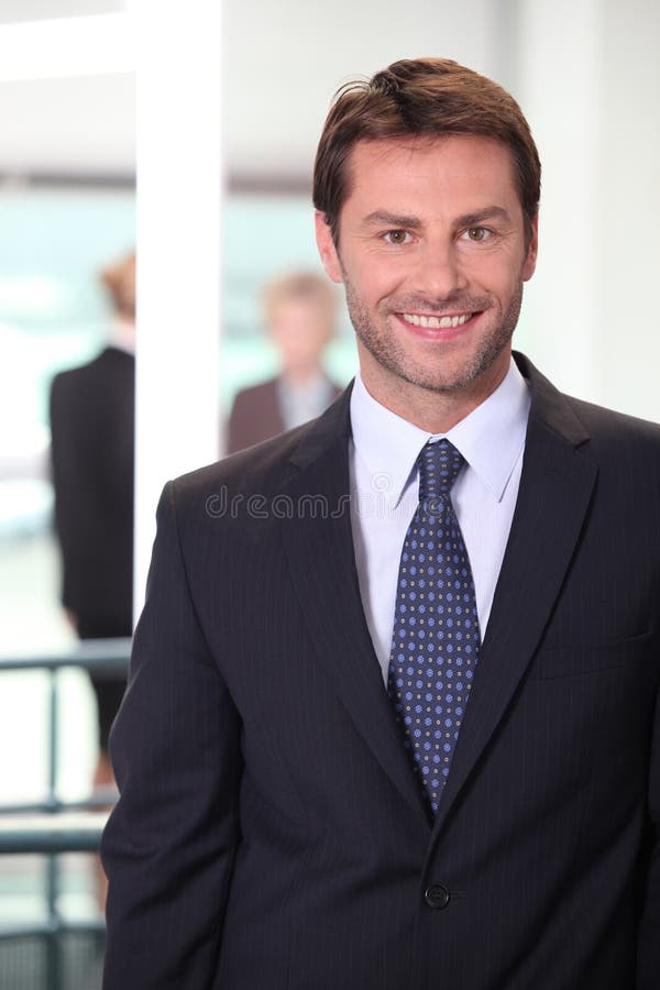 Smiling Business Man Standing Stock Image - Image of employee, office ...