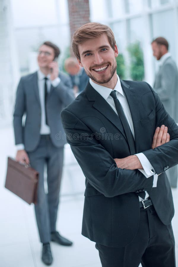 Smiling Business Man Standing in a Modern Office Stock Image - Image of ...