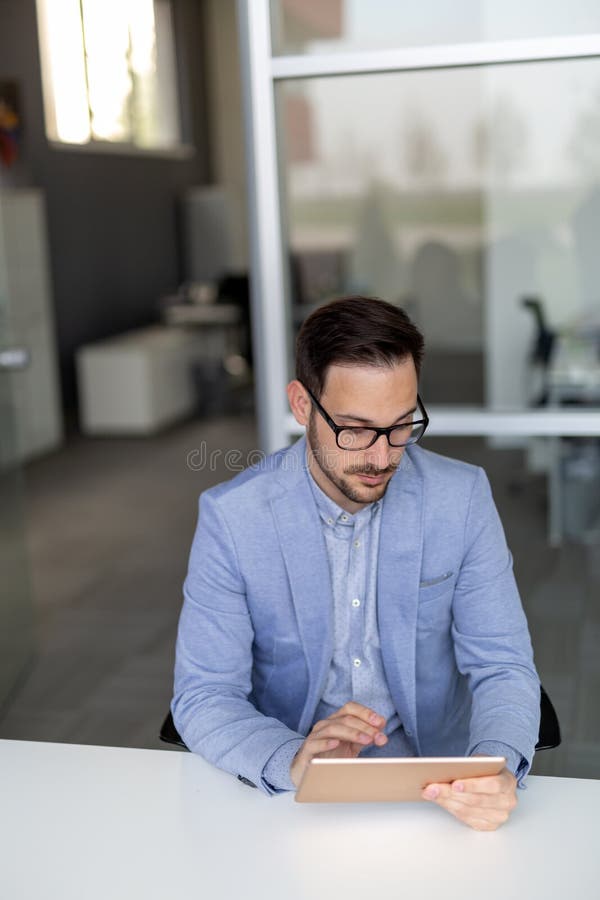 Smiling Business Man Using Digital Tablet in the Office Stock Photo ...
