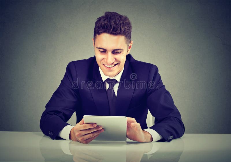 Smiling Young Businessman Using a Tablet Computer Stock Photo - Image ...