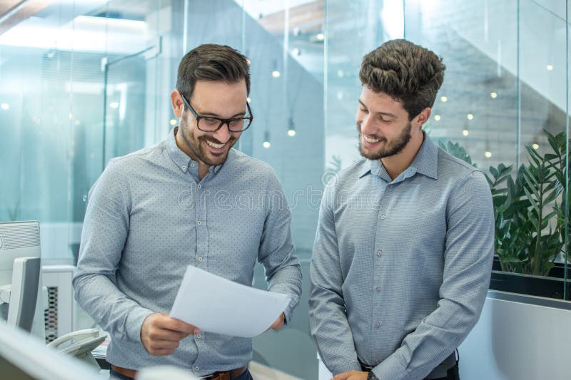 Smiling Business Men Discussing Document in Office Stock Image - Image ...